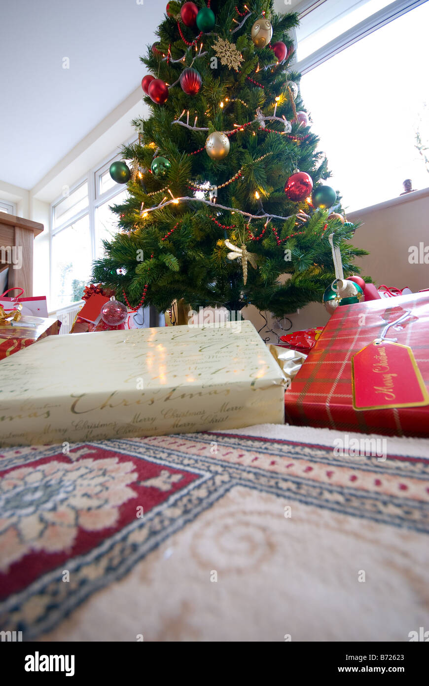 A zoomed photograph of christmas tree, baubles and presents Stock Photo ...
