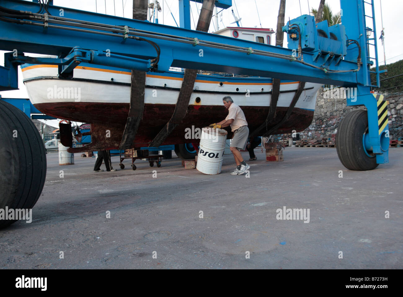Manouvering oil barrels and wood blocks into position to support the ...