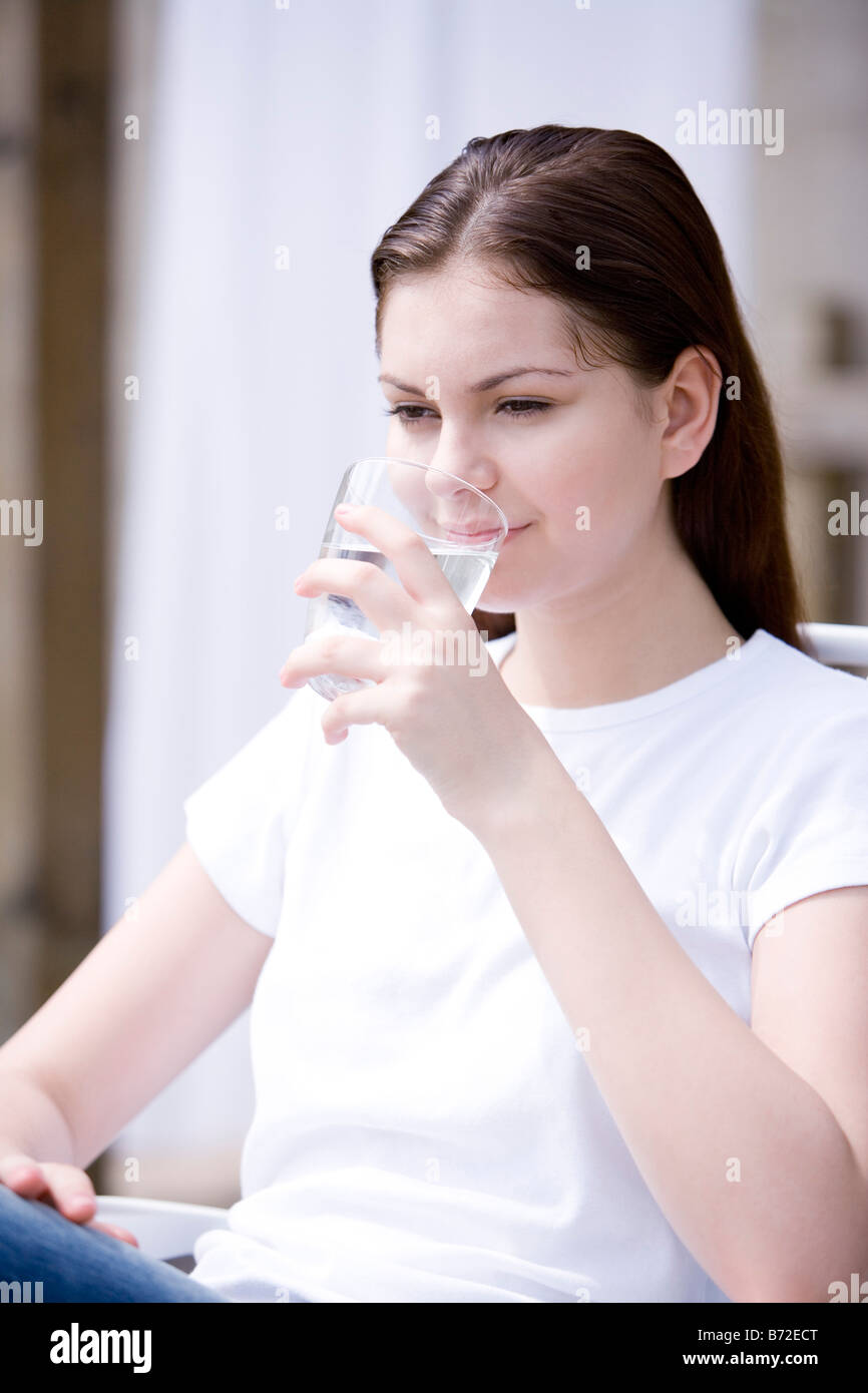 Teenage girl drinking water smiling portrait Stock Photo - Alamy