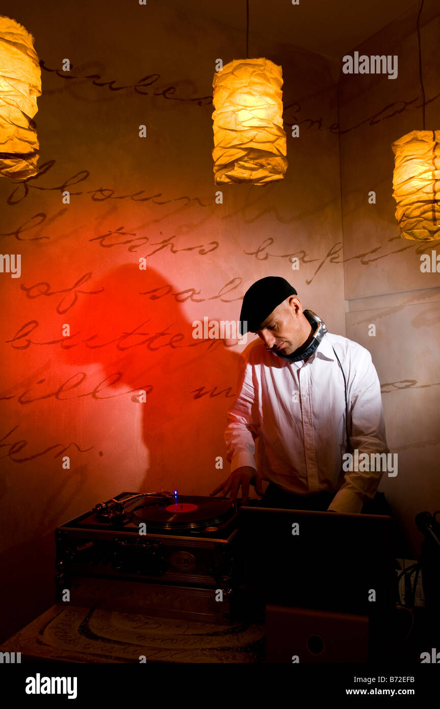 Young deejay playing music in a warm atmosphere Stock Photo - Alamy