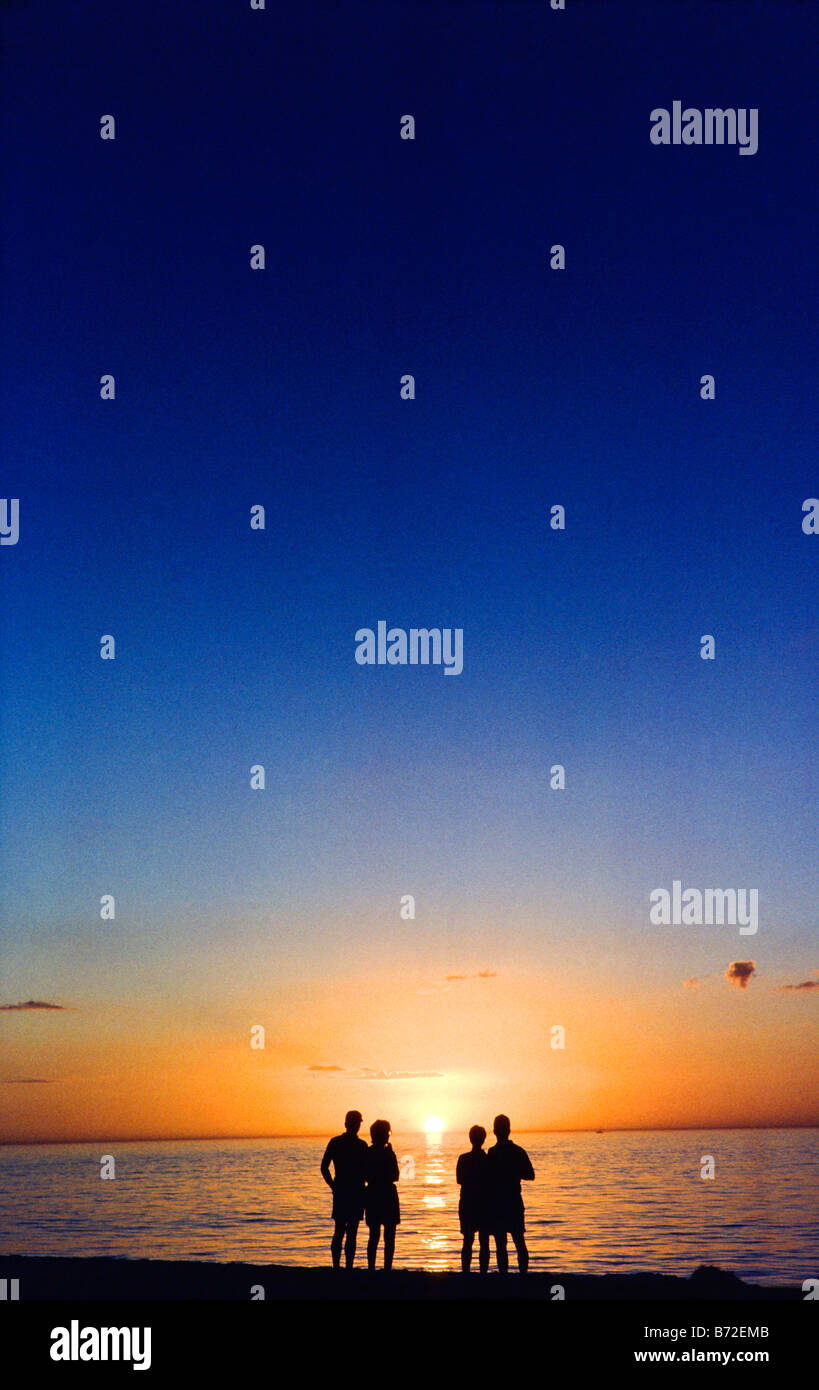 Two couples wacthing sunset over ocean together, Miami Stock Photo - Alamy