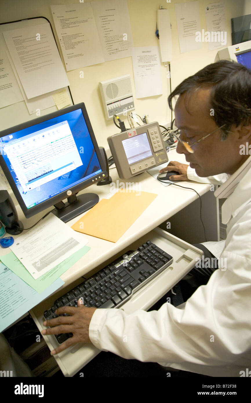 Doctor working on computer Stock Photo - Alamy