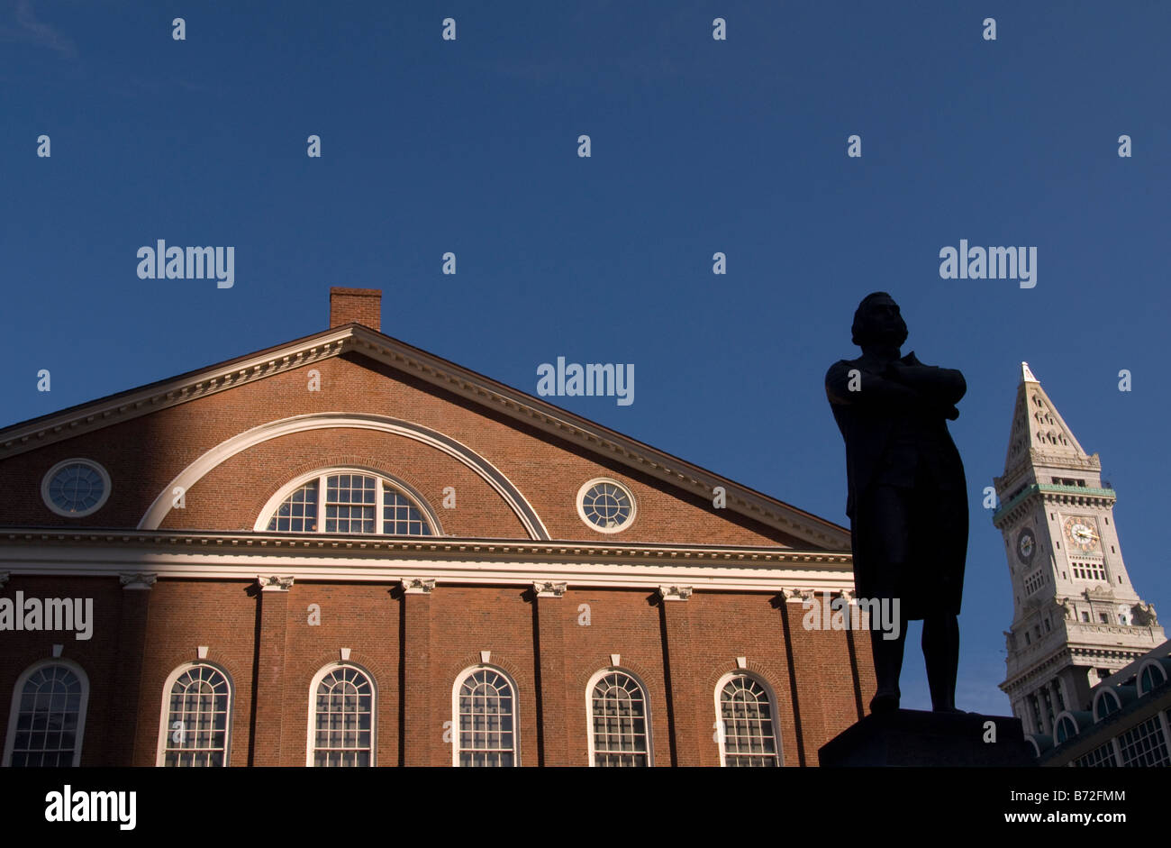 Faneuil Hall and silhouette of Samuel Adams statue with Custom House in ...