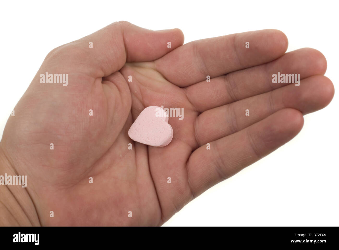 hand with heart shaped sweet isolated on a white background Stock Photo ...
