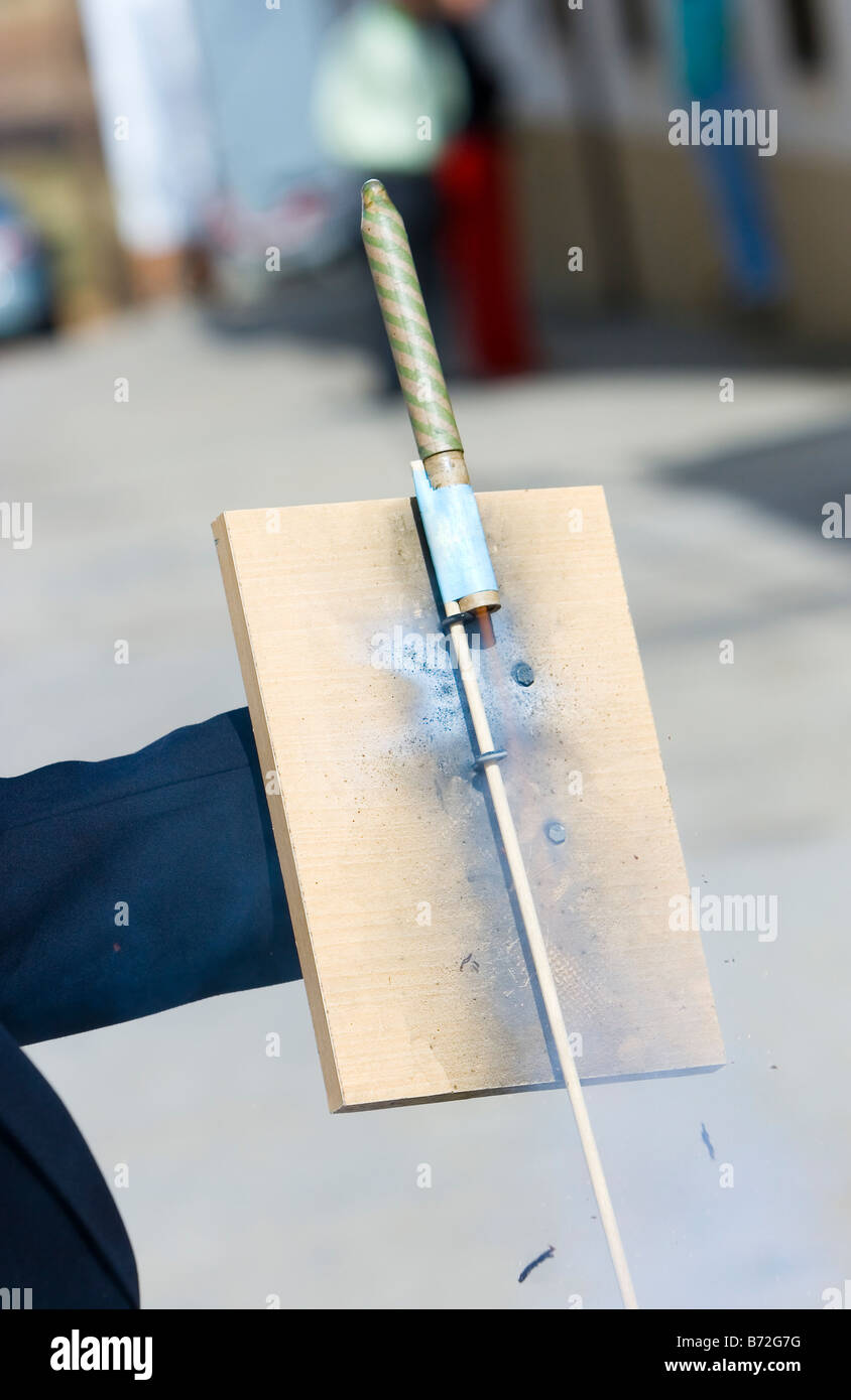 a man launching fireworks rockets with his hands Stock Photo - Alamy