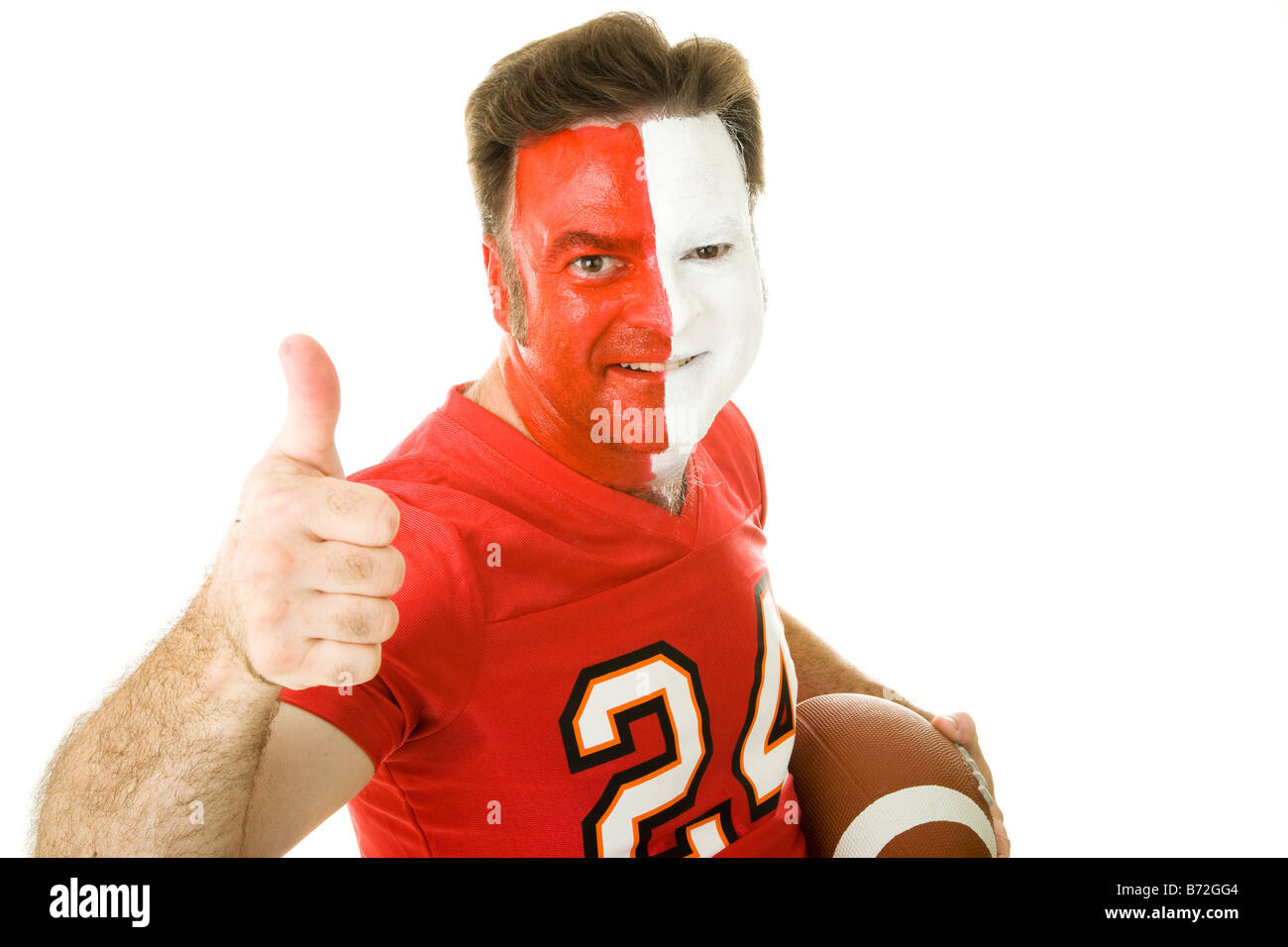 Football fan in jersey and face paint giving a thumbs up sign Isolated ...