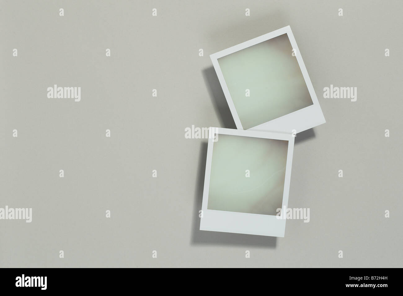 2 blank polaroids on grey background Stock Photo - Alamy