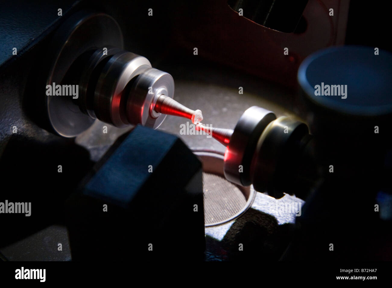 Diamond cutting machine cutting a spinning diamond. Diamond workshop in ...