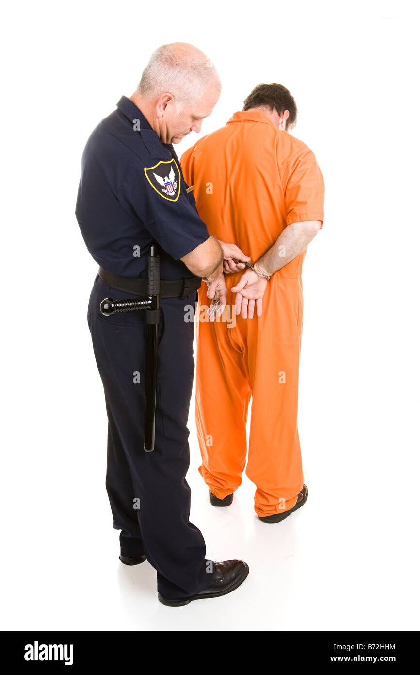 Police officer putting handcuffs on prisoner in orange jumpsuit ...