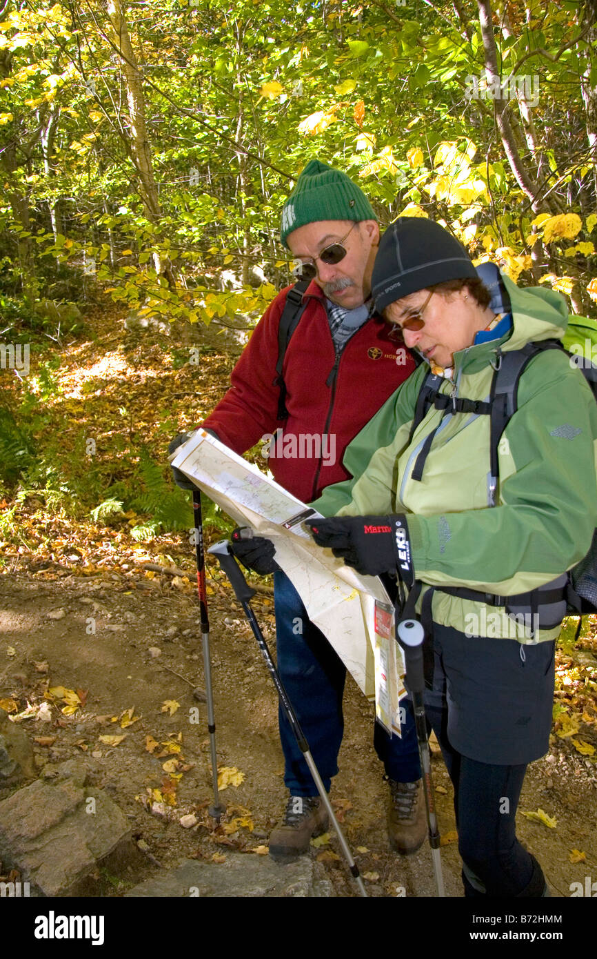 Hikers read a map at the northern end of the Franconia Range in the ...