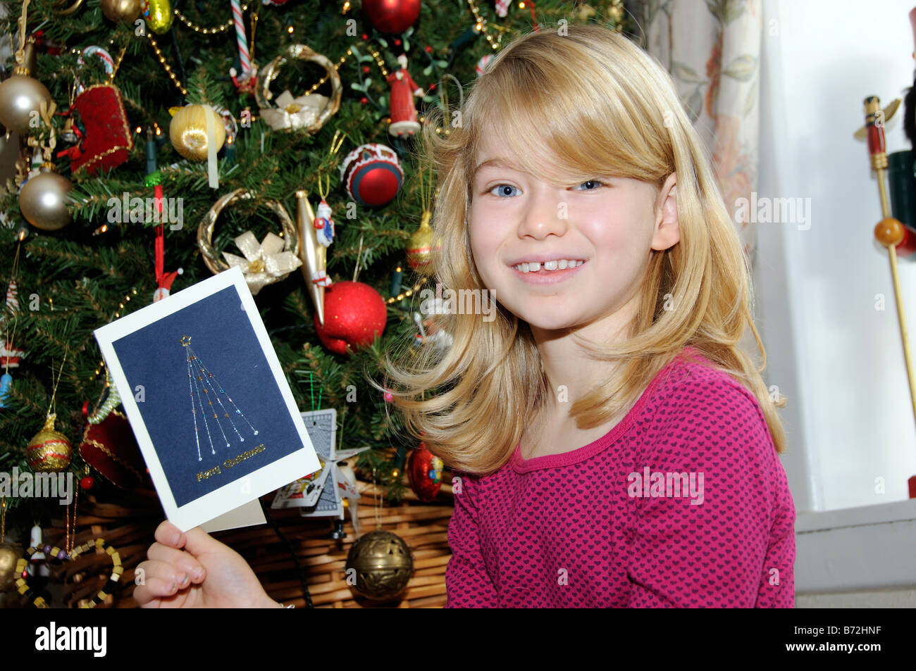 Little girl reading a christmas greeting card Stock Photo - Alamy