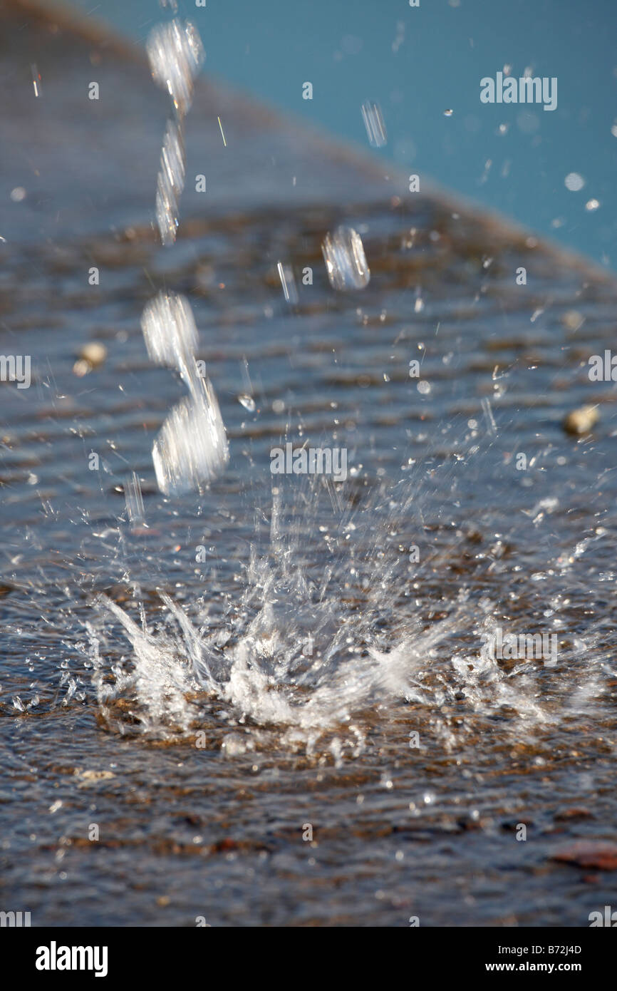 water dripping hitting concrete and making a splash county down ...