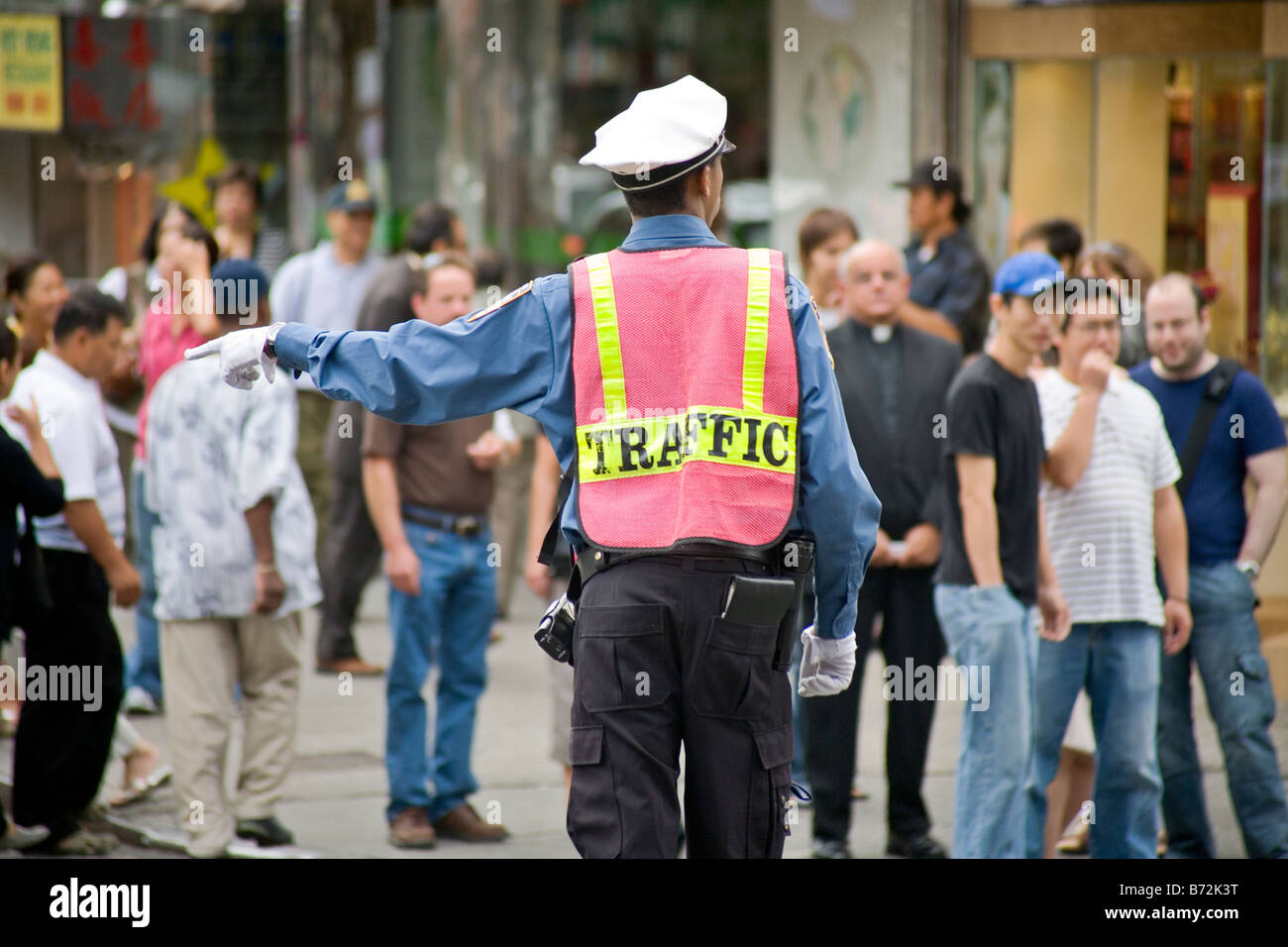 A traffic cop directs traffic at an intersection in New York City Stock ...