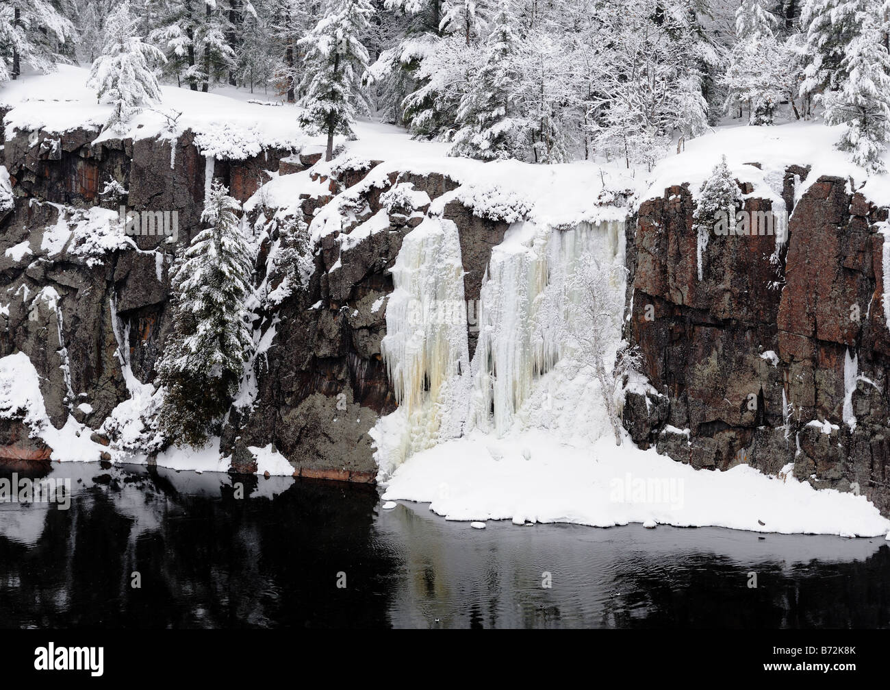 A frozen waterfall on the cliffs bordering the French River, Ontario ...