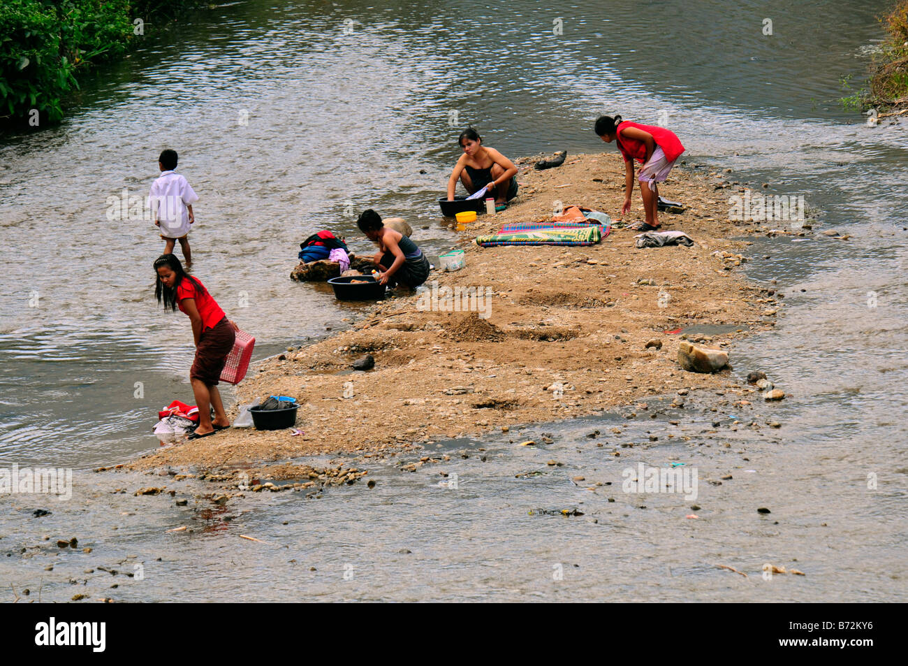 Refugee are washing their clothes in the river near Maela Refugee camp ...