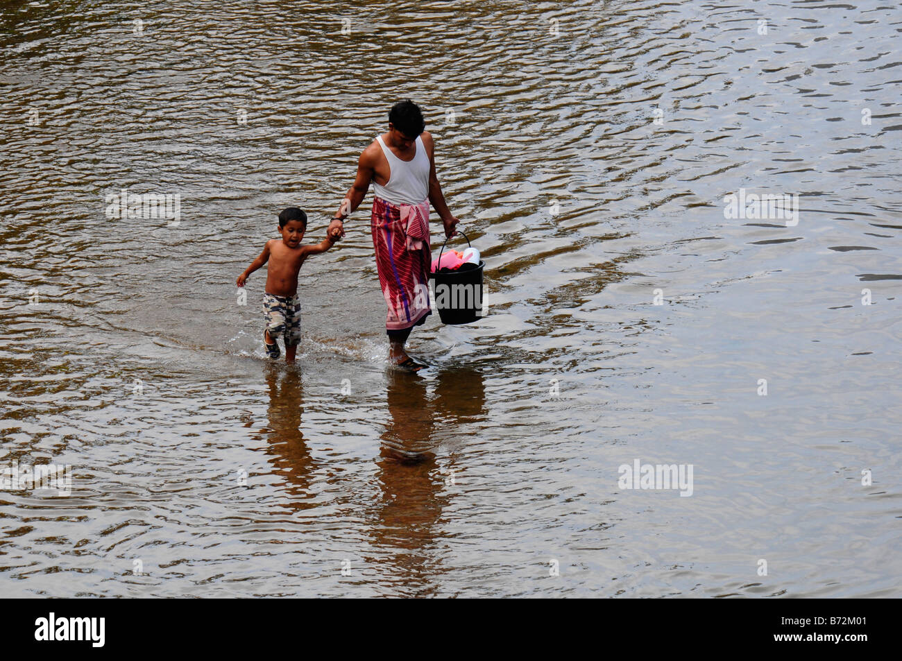 Burmese refugee, Father and little boy are going to have shower in the ...