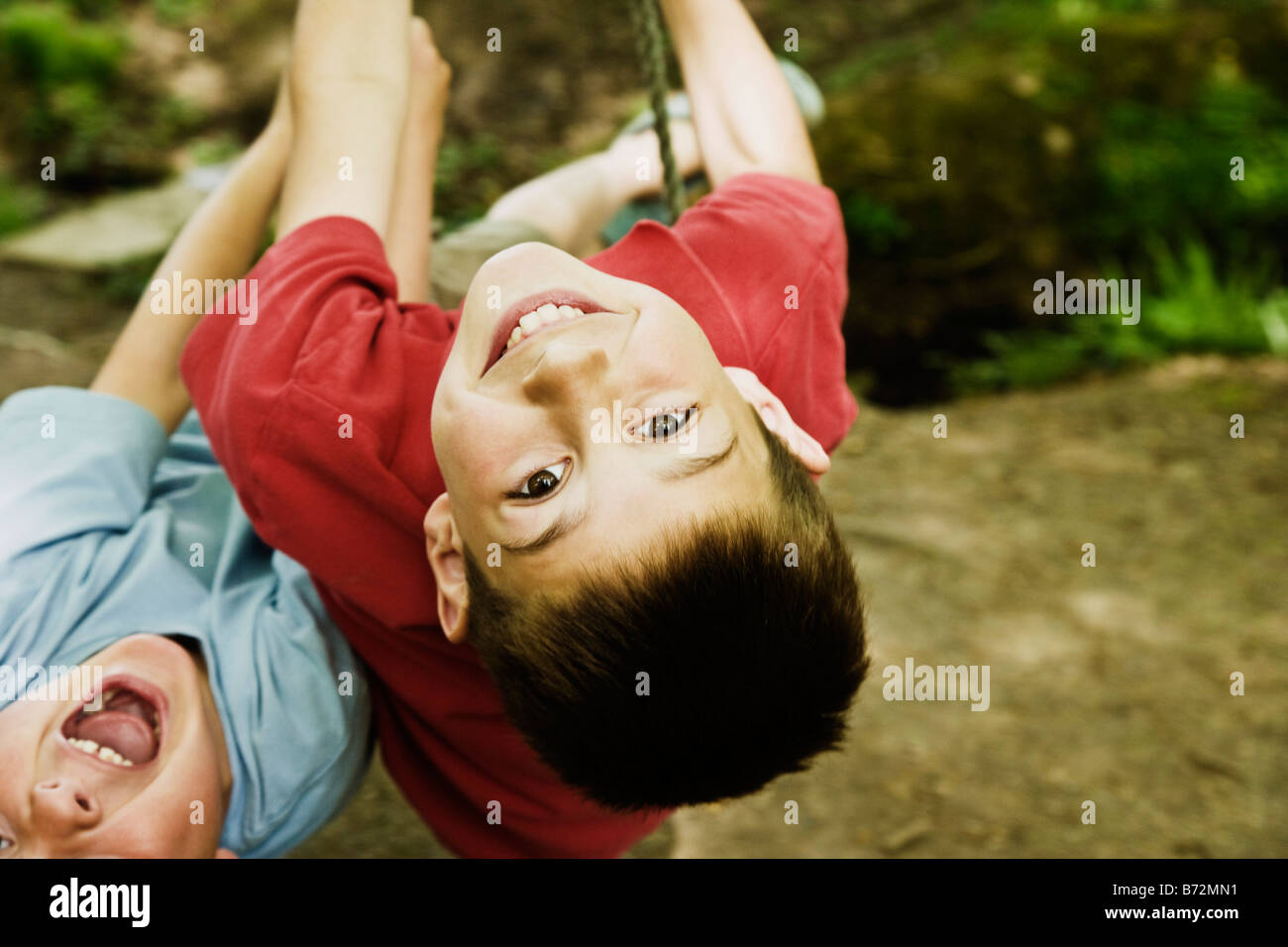 two boys on a rope swing Stock Photo - Alamy
