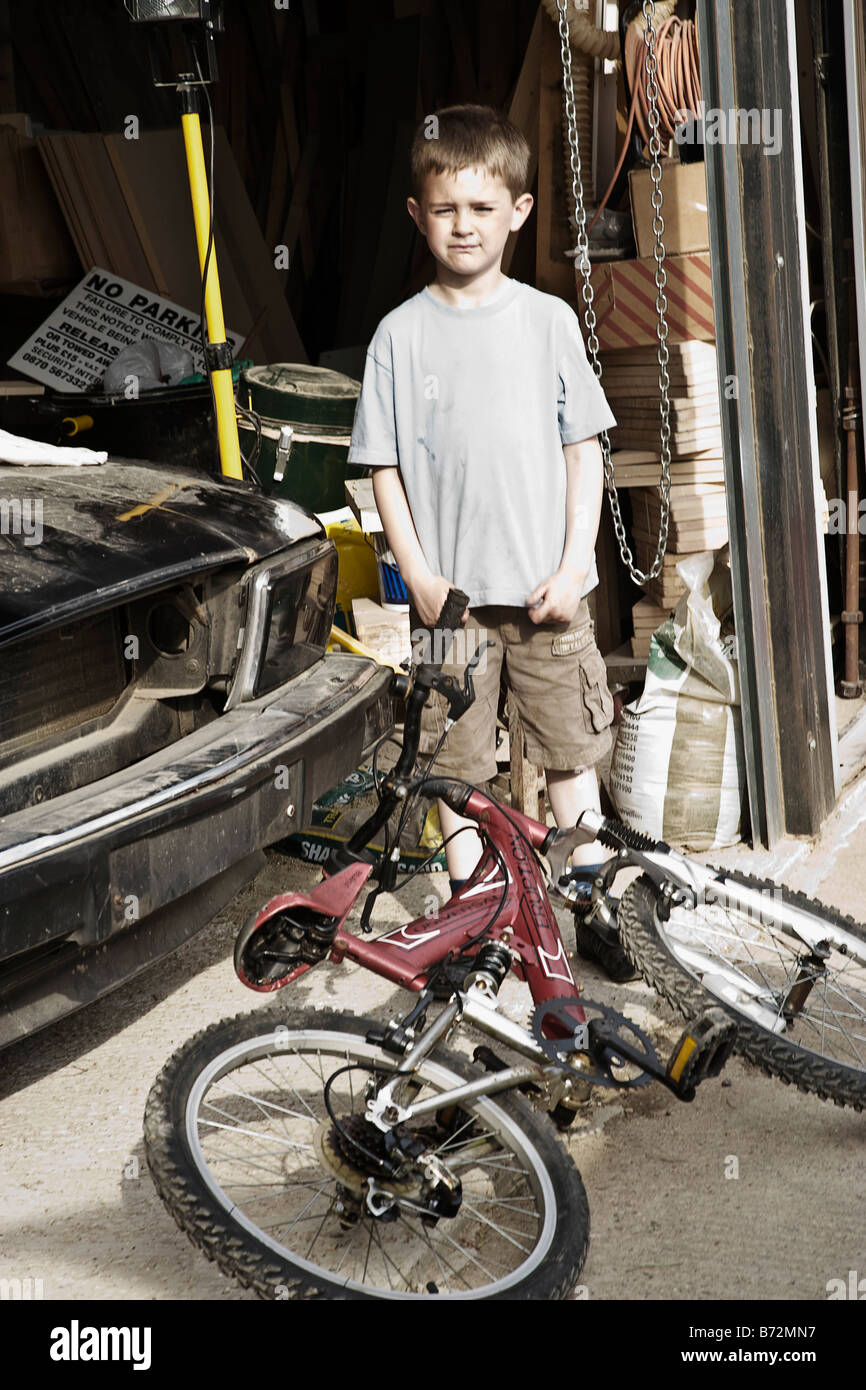 Boy standing with a car in a garage Stock Photo - Alamy