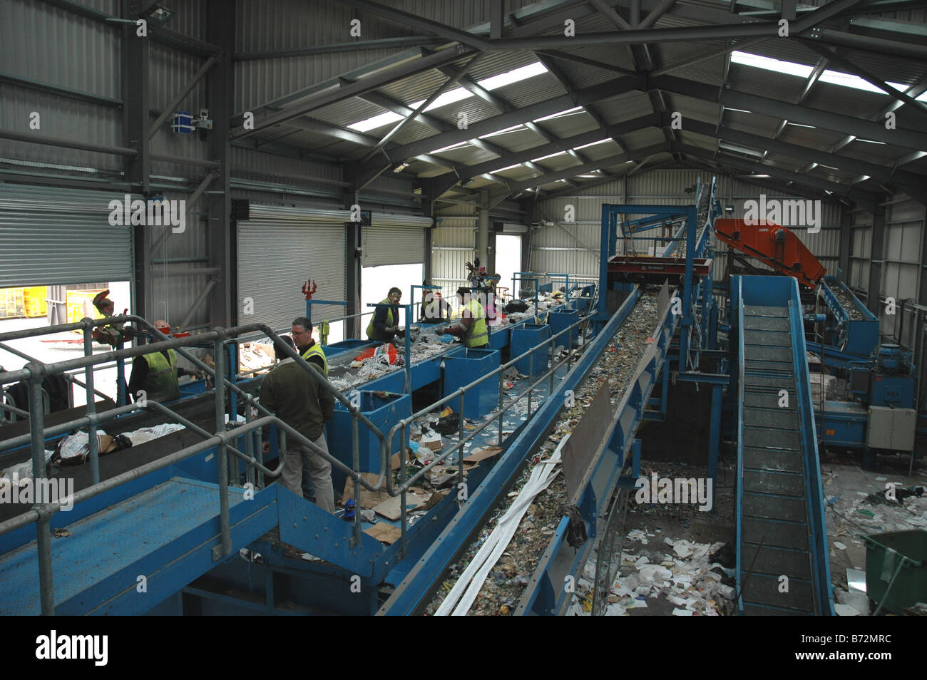 Men at work in a modern recycling centre preparing commercial waste to ...