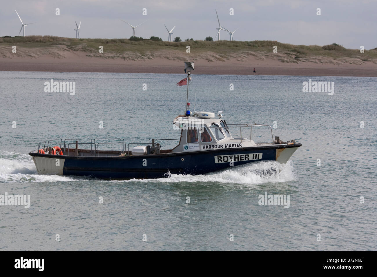 The Rother III harbour master leaving Rye Harbour. In the backround are ...