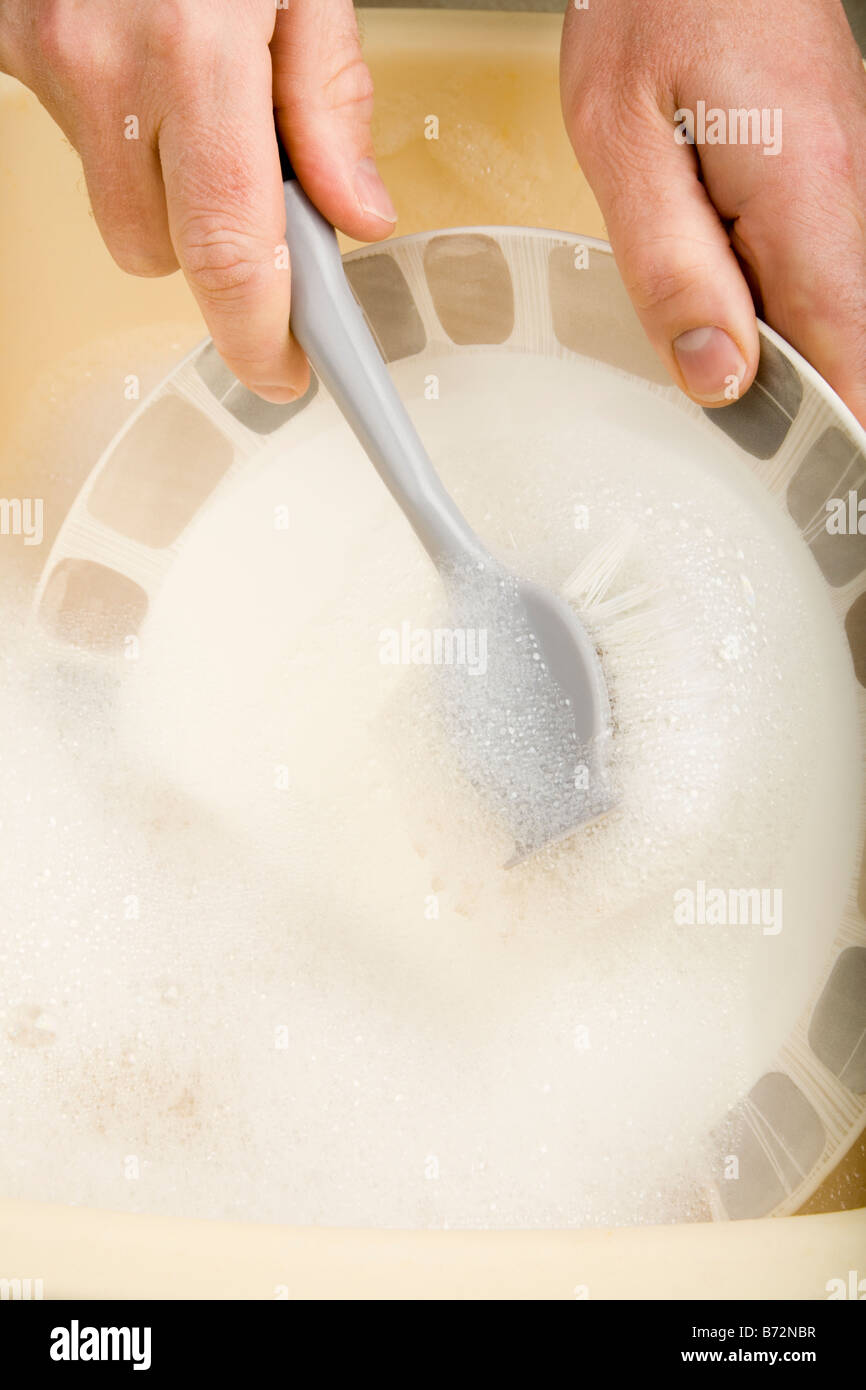 Washing up or washing the dishes Stock Photo - Alamy