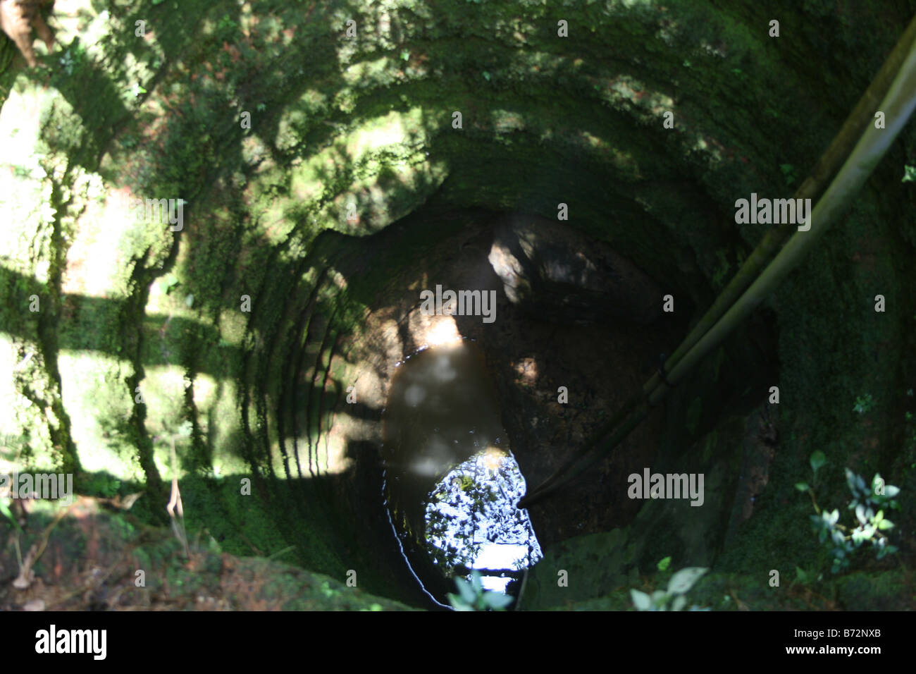 Ancient manmade deep well modified with new water motor pump and pipe ...