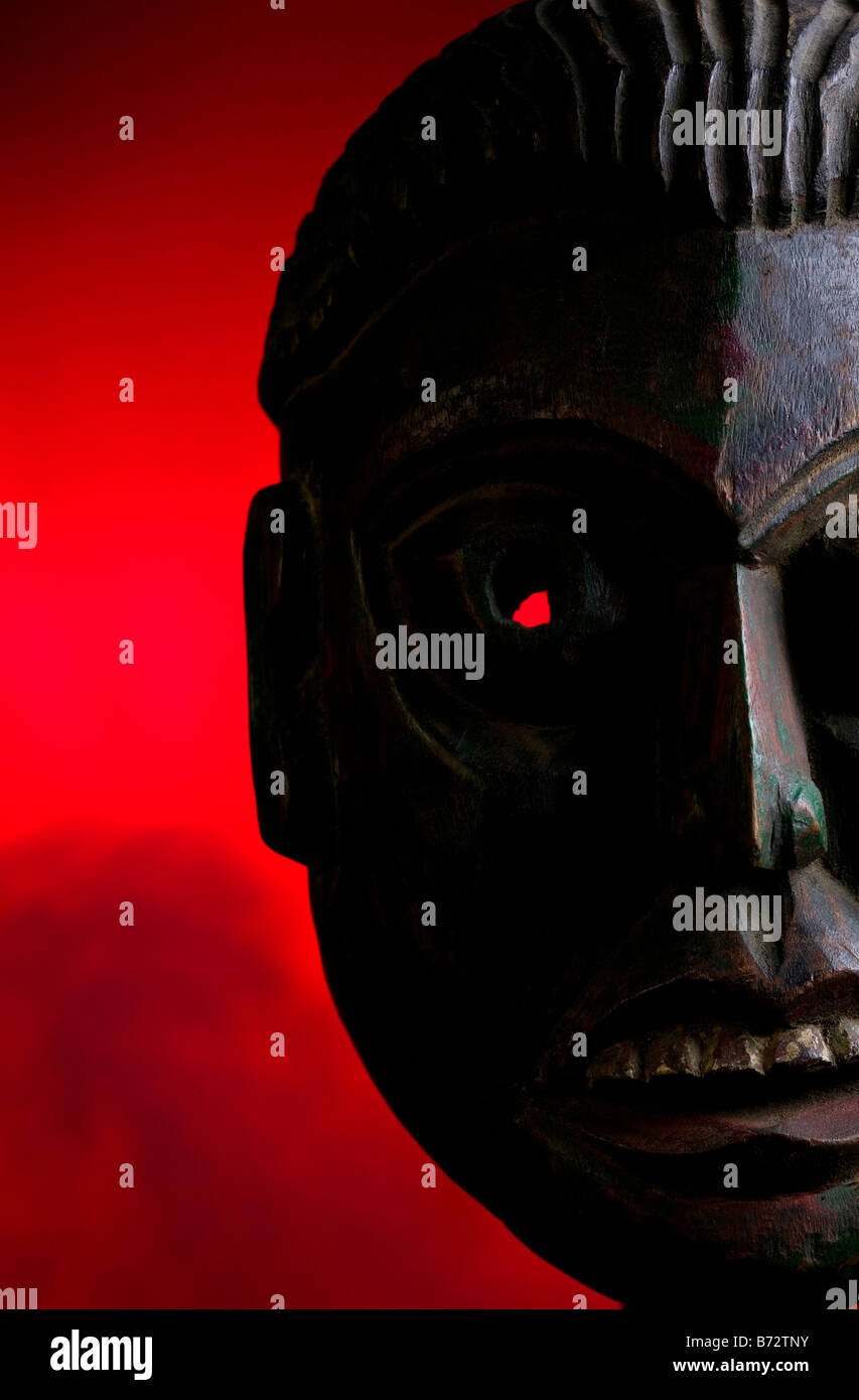 Tribal mask on a red smokey background Stock Photo - Alamy