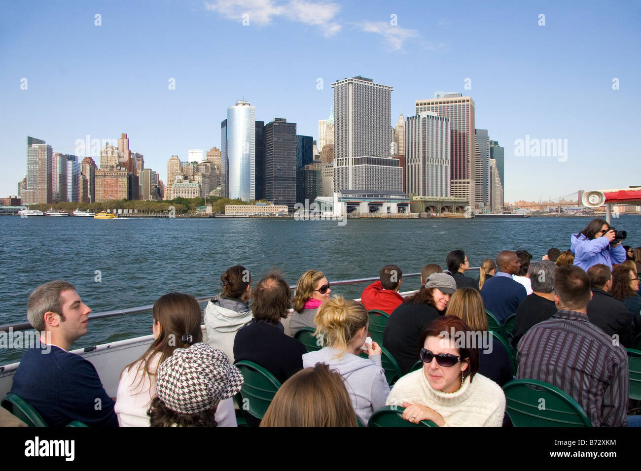 Passengers on a New York Harbor tour boat view Lower Manhattan New York ...