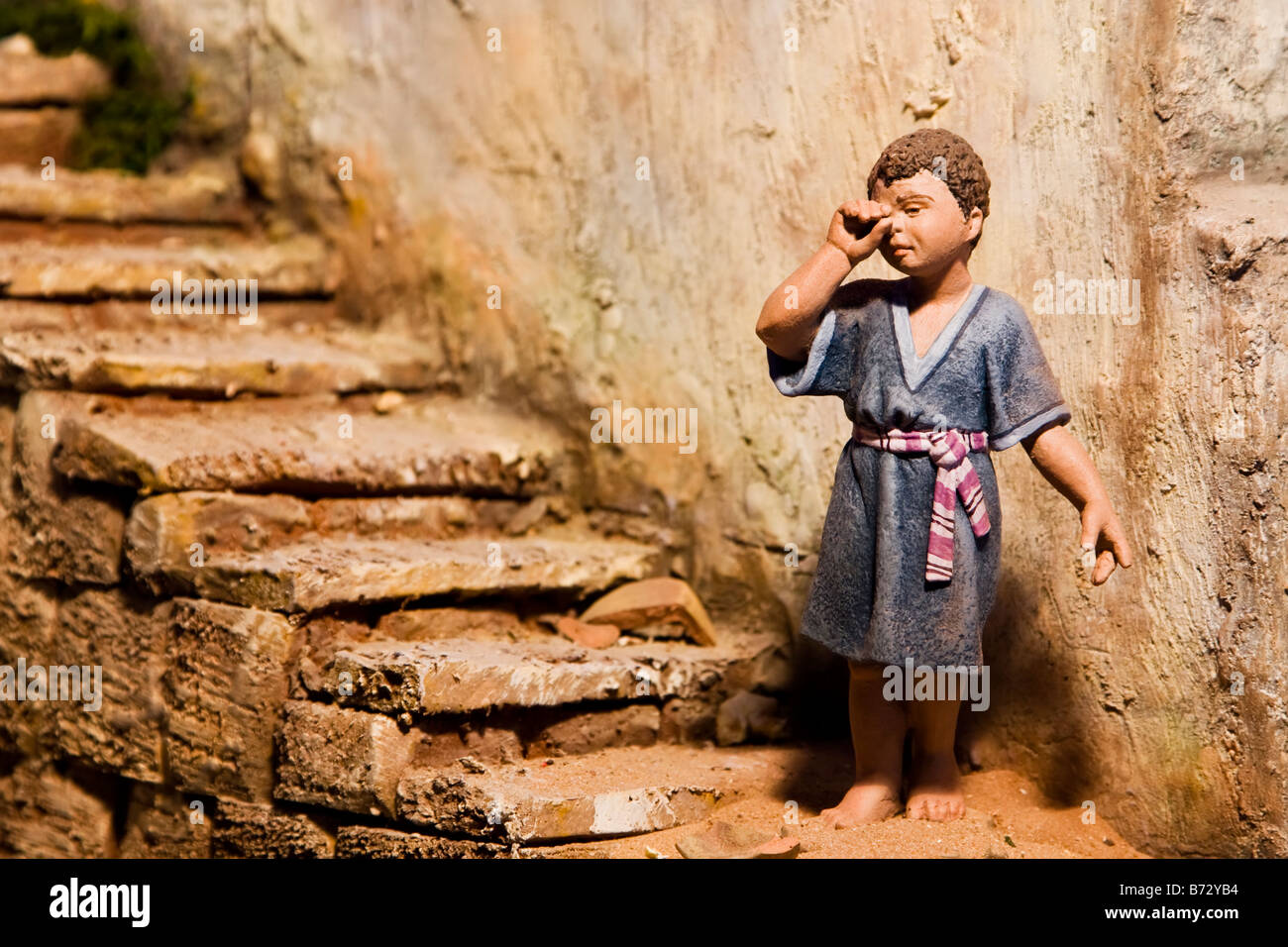 Figurine representing crying arabic child Stock Photo - Alamy