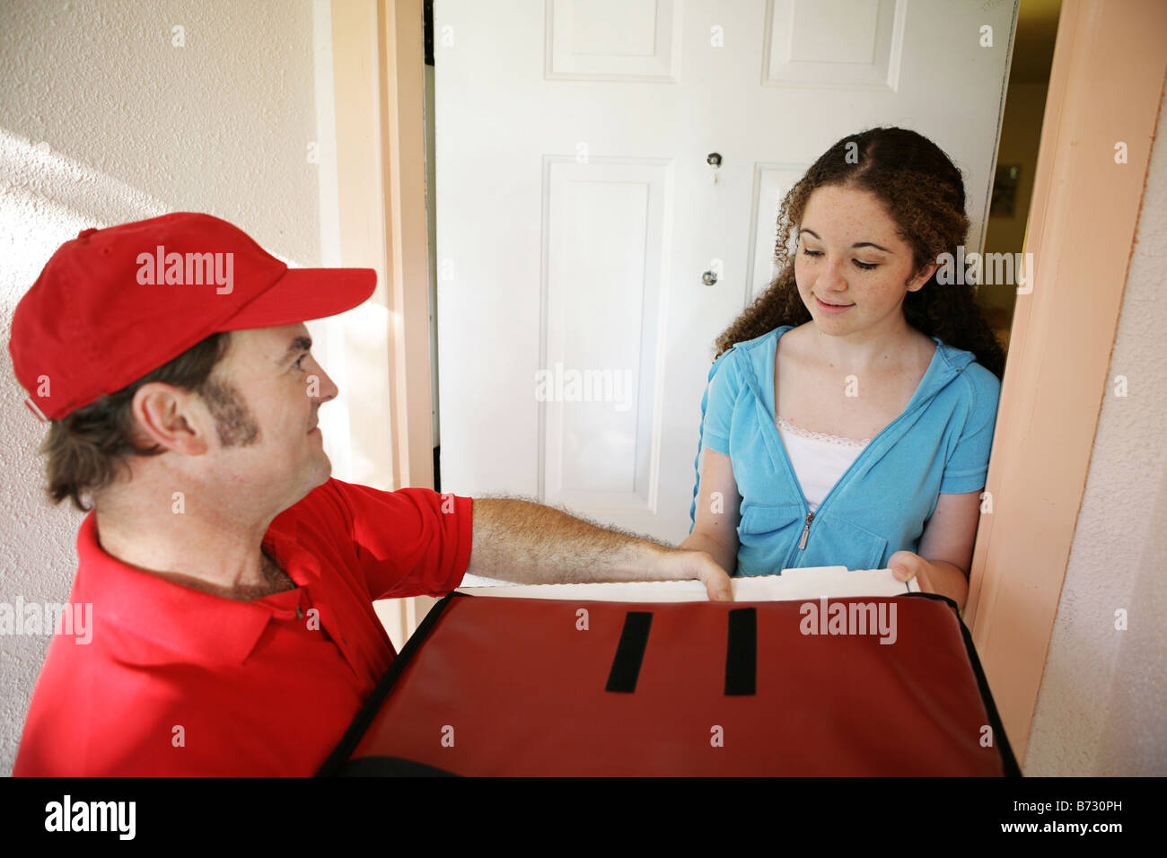 A delivery man bringing pizza to a home Stock Photo - Alamy