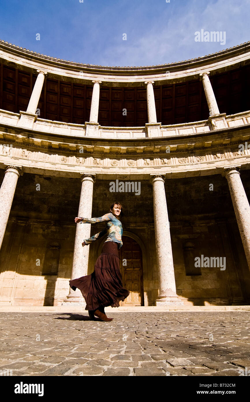 Happy young woman dancing in monumental building Stock Photo - Alamy
