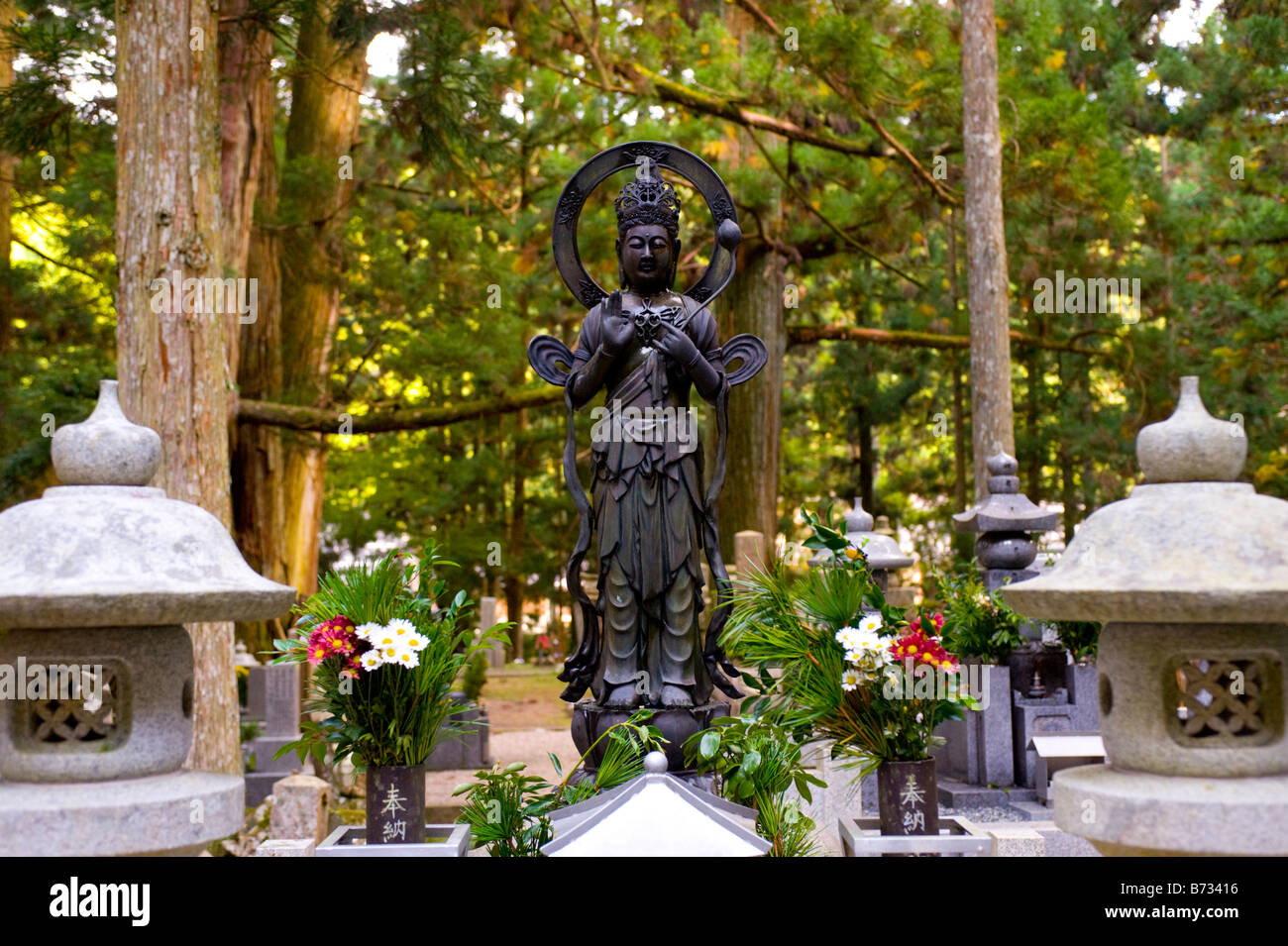 A Jizo Statue and tomb in Okunoin Cemetery on Mount Koya in Koyasan ...