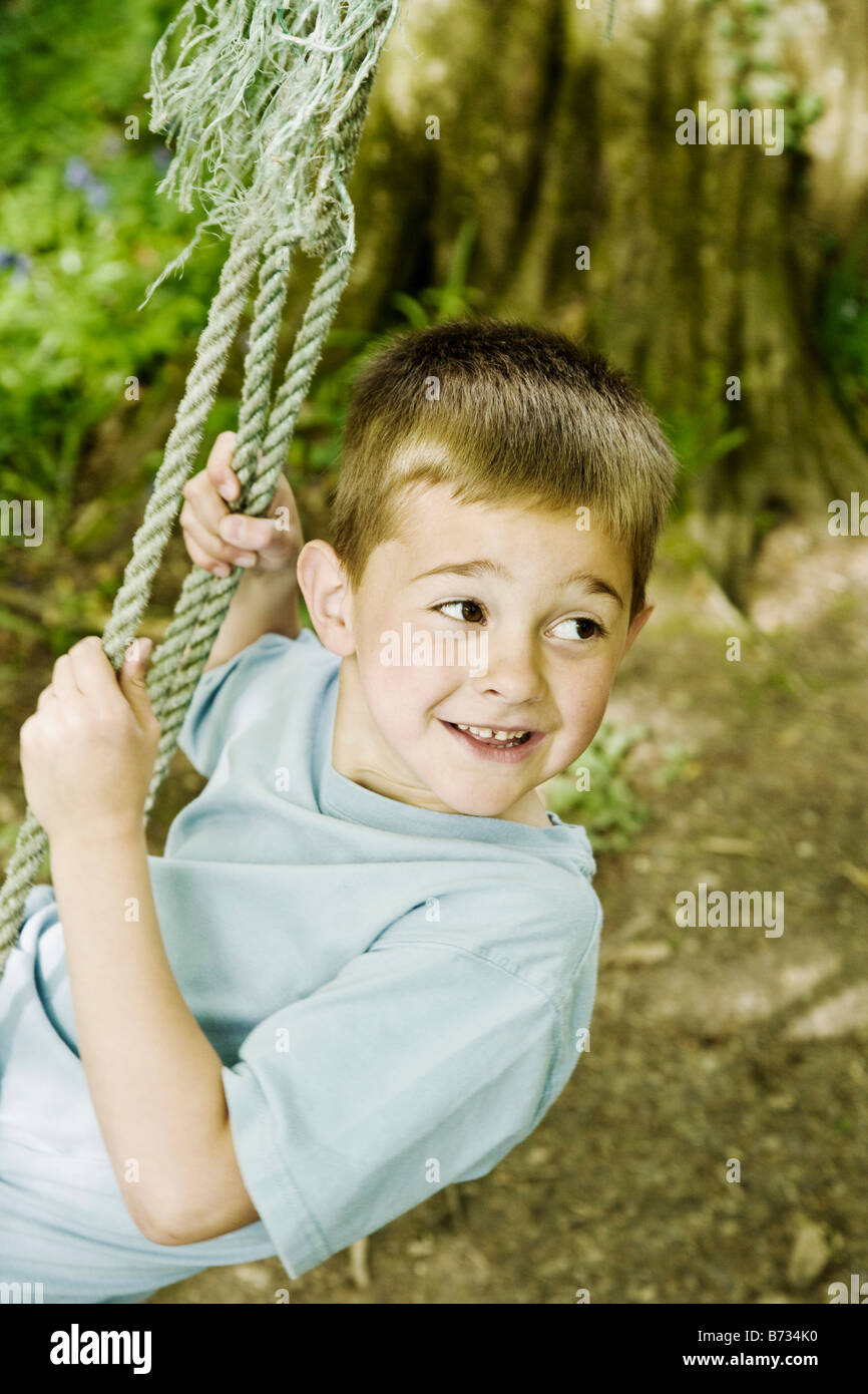 Boy having fun on a rope swing Stock Photo - Alamy
