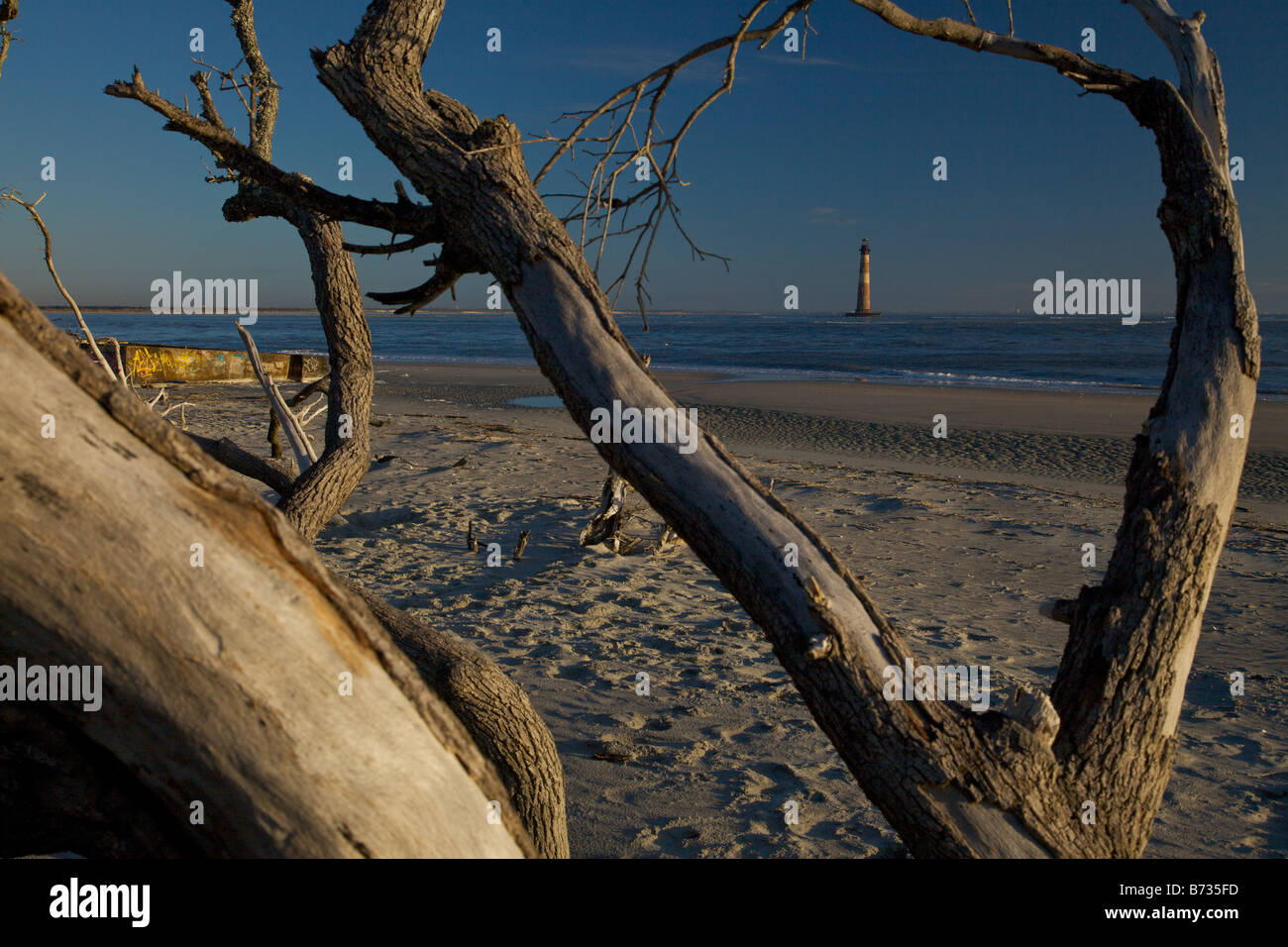 Sunrise over Folly Beach viewing the Morris Lighthouse through ...
