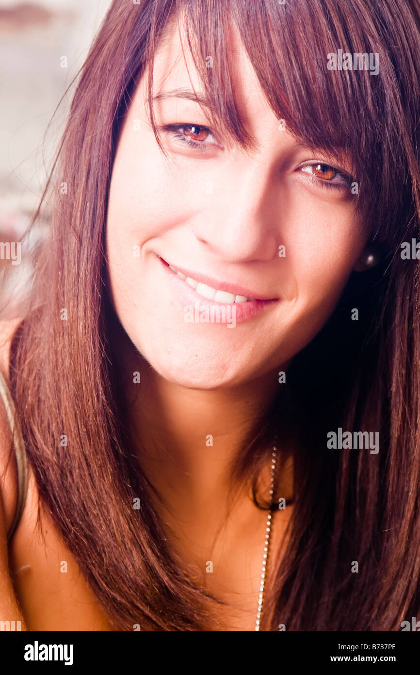 Young woman smiling at camera Stock Photo - Alamy