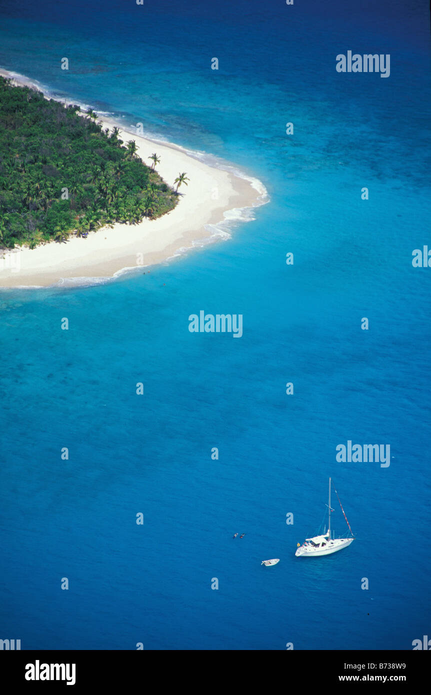 Perfect white sandy beach with clear blue water and a boat in ...