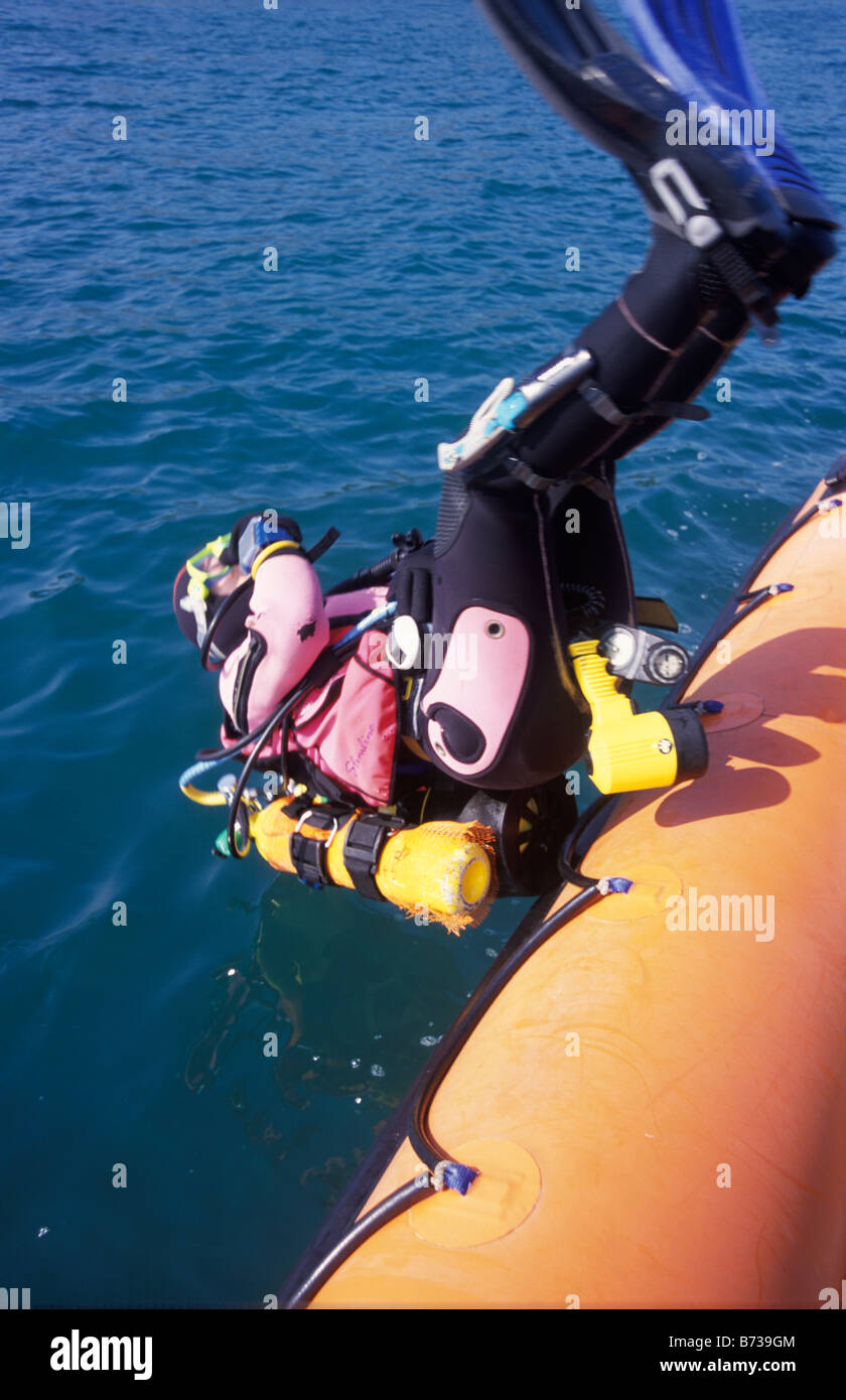 Scuba diver entering water from an inflatable boat Pembrokeshire West ...
