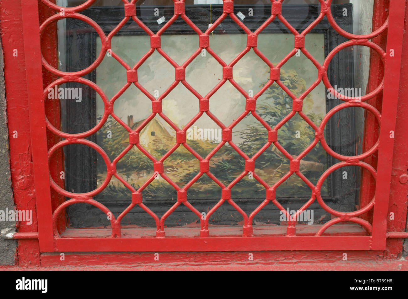 A painting behind the grating of a shop window in Krakow Poland Stock ...