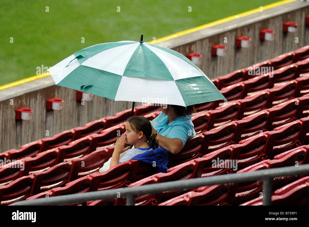 Baseball fans wait for the start of a game in the rain in Cincinnati ...