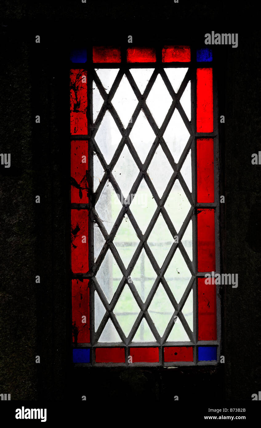 red stained glass light shining though window Stock Photo - Alamy