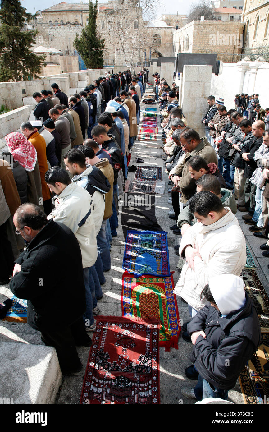 Palestinian Muslims praying in the Old City of Jerusalem Stock Photo ...