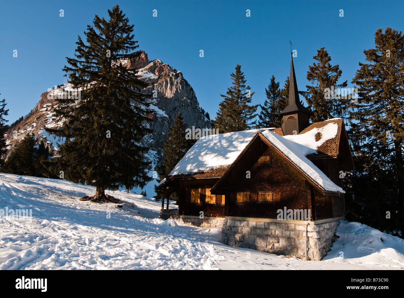 old wooden chapel in swiss alps in fron of the mythen mountain ...