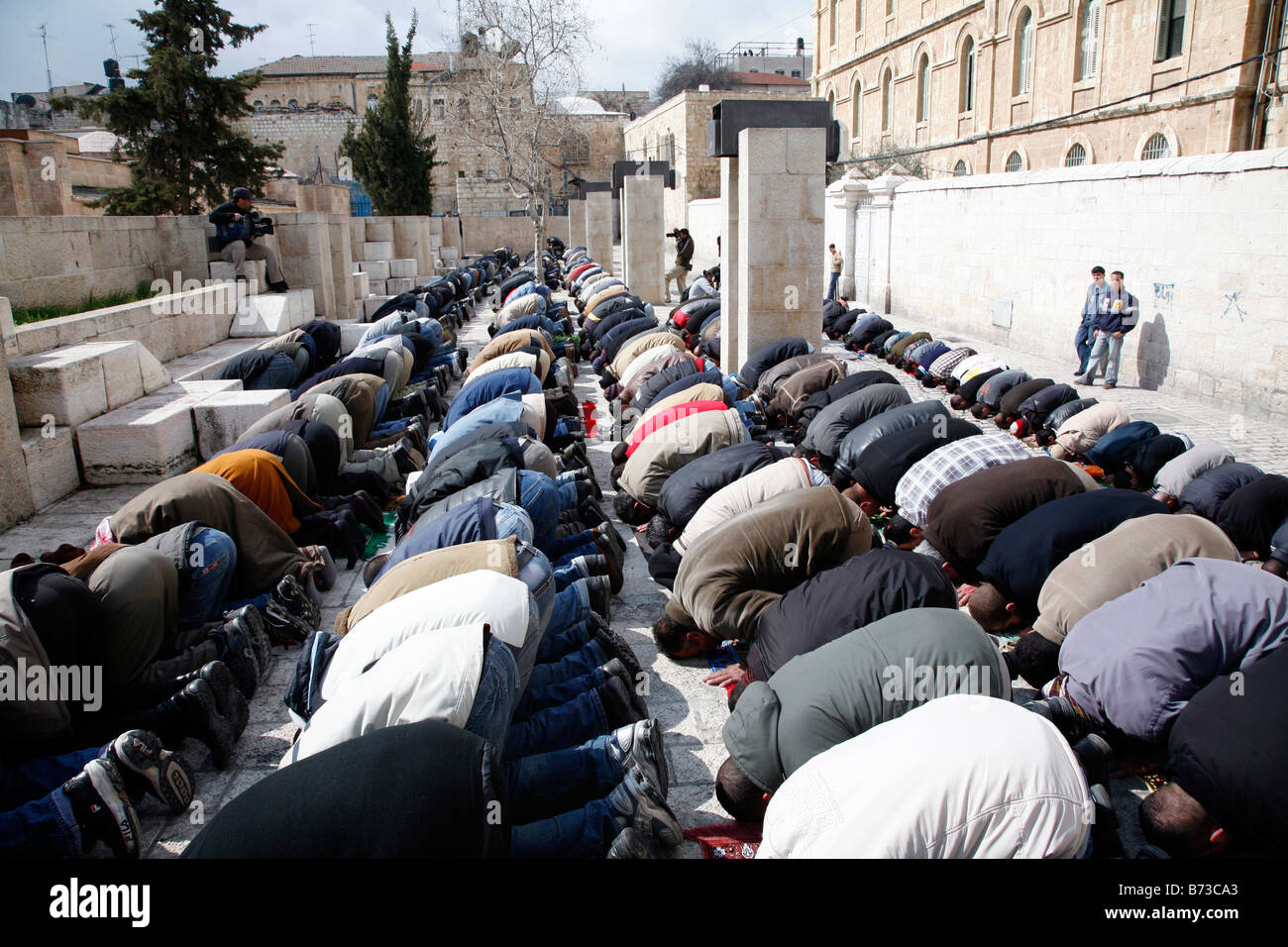 Palestinian Muslims praying in the Old City of Jerusalem Stock Photo ...