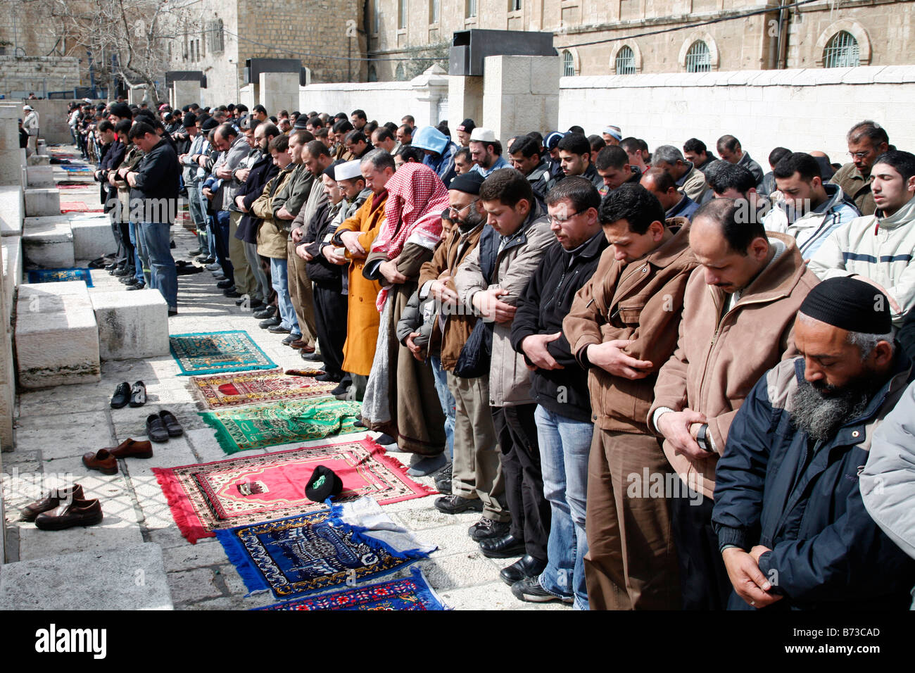Palestinian Muslims praying in the Old City of Jerusalem Stock Photo ...