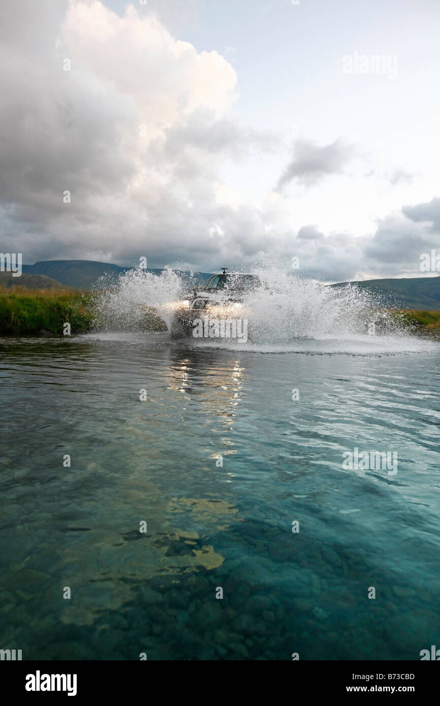 4x4 crossing a river with a big splash Stock Photo - Alamy