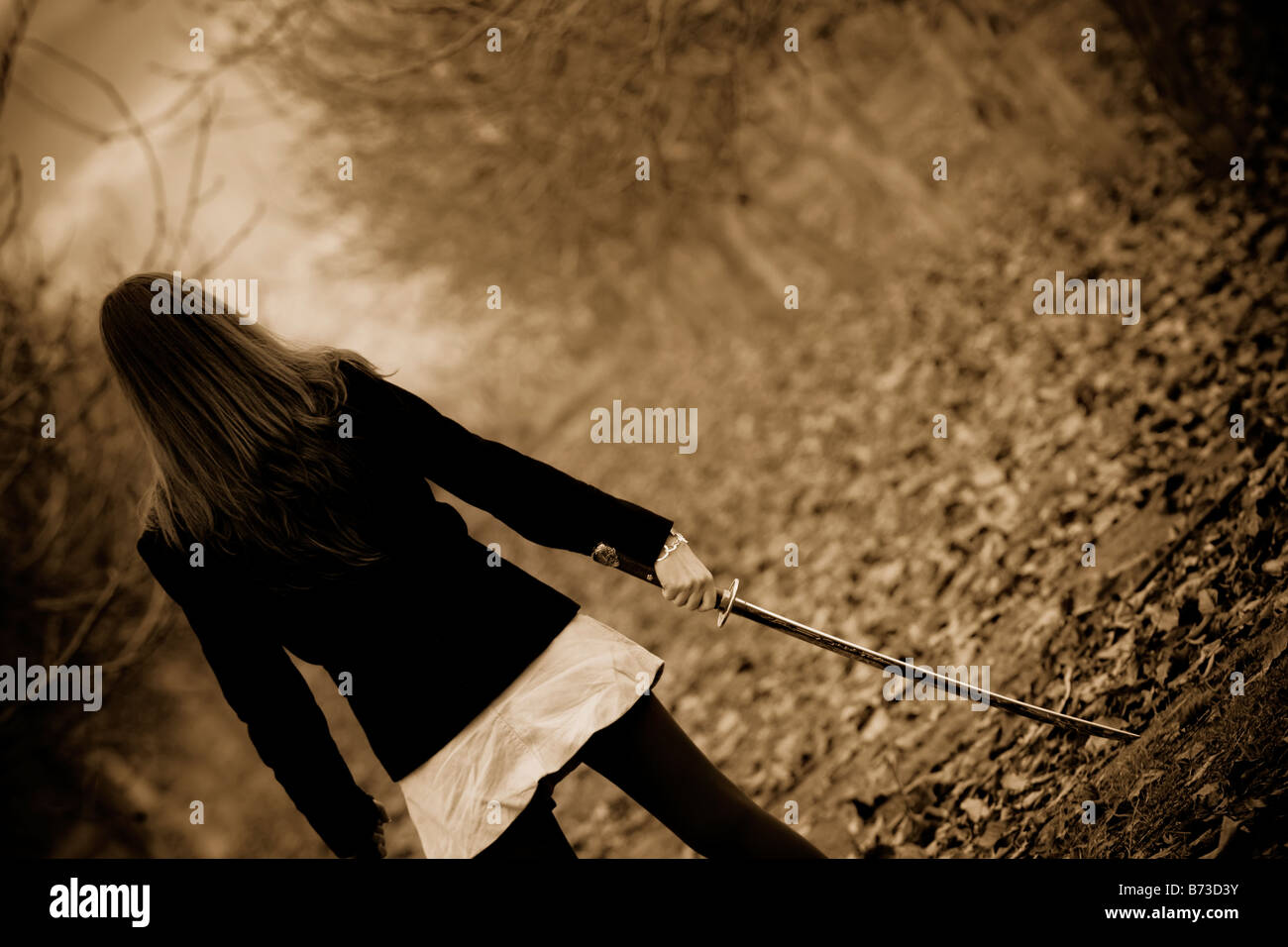 Young woman holding katana sword sepia toned Stock Photo - Alamy