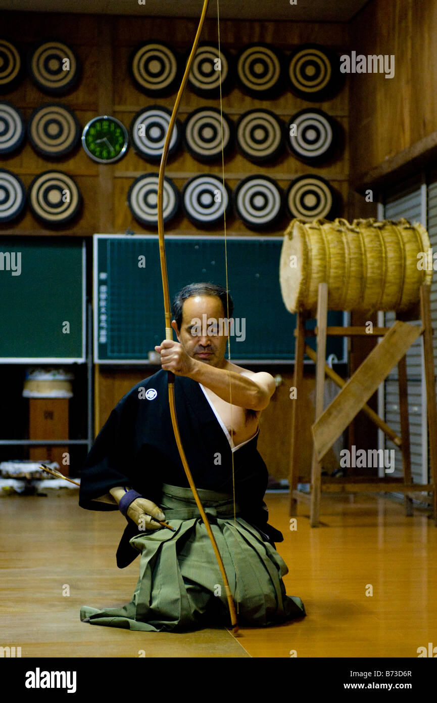 A Kyudoka stringing his bow in a Dojo in Yudanaka, Japan Stock Photo ...