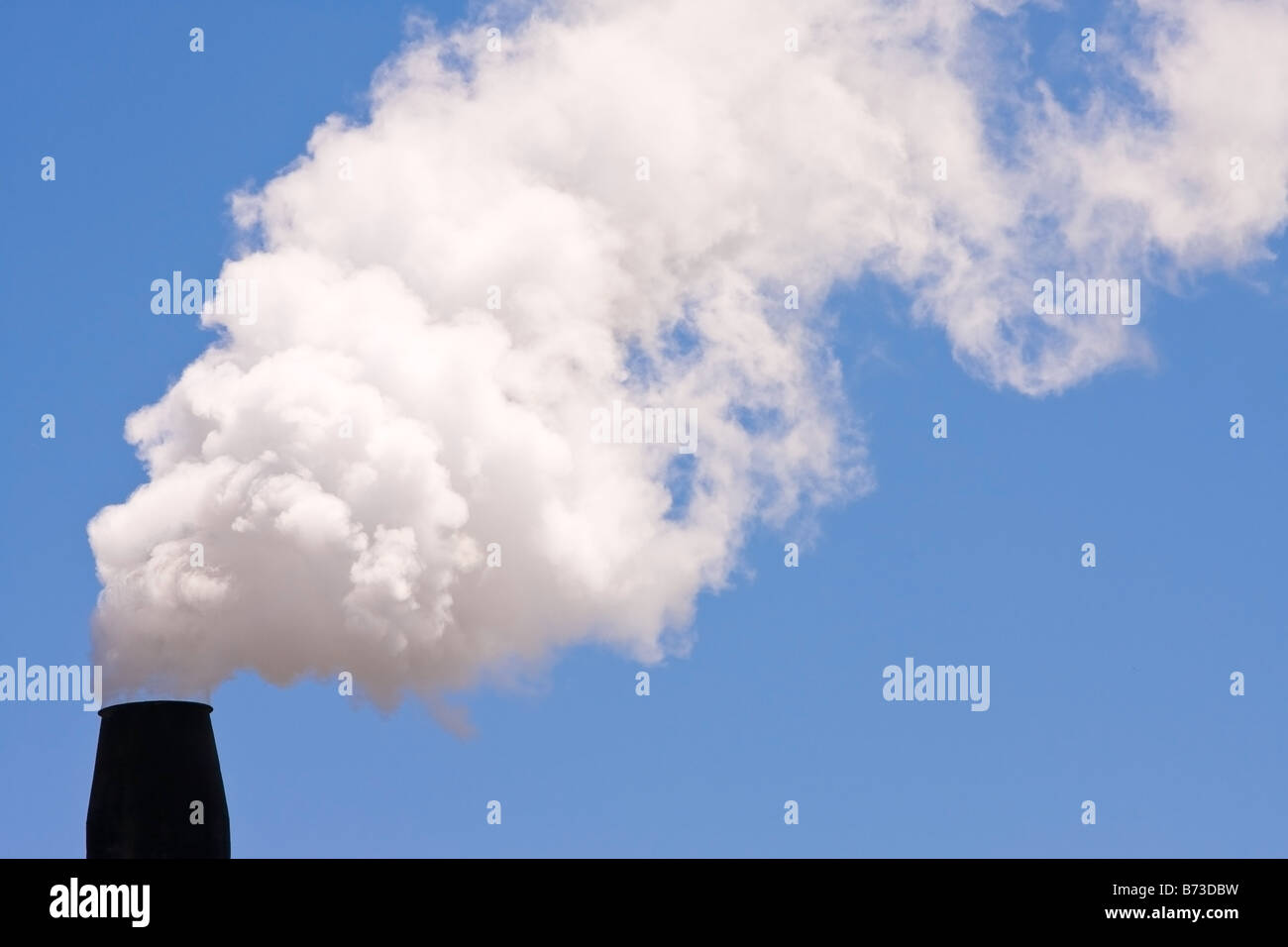 Smoking chimney against clear blue hi-res stock photography and images ...