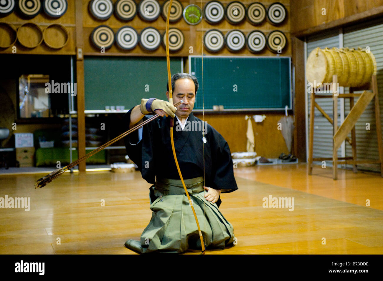 A Kyudoka stringing his bow in a Dojo in Yudanaka, Japan Stock Photo ...