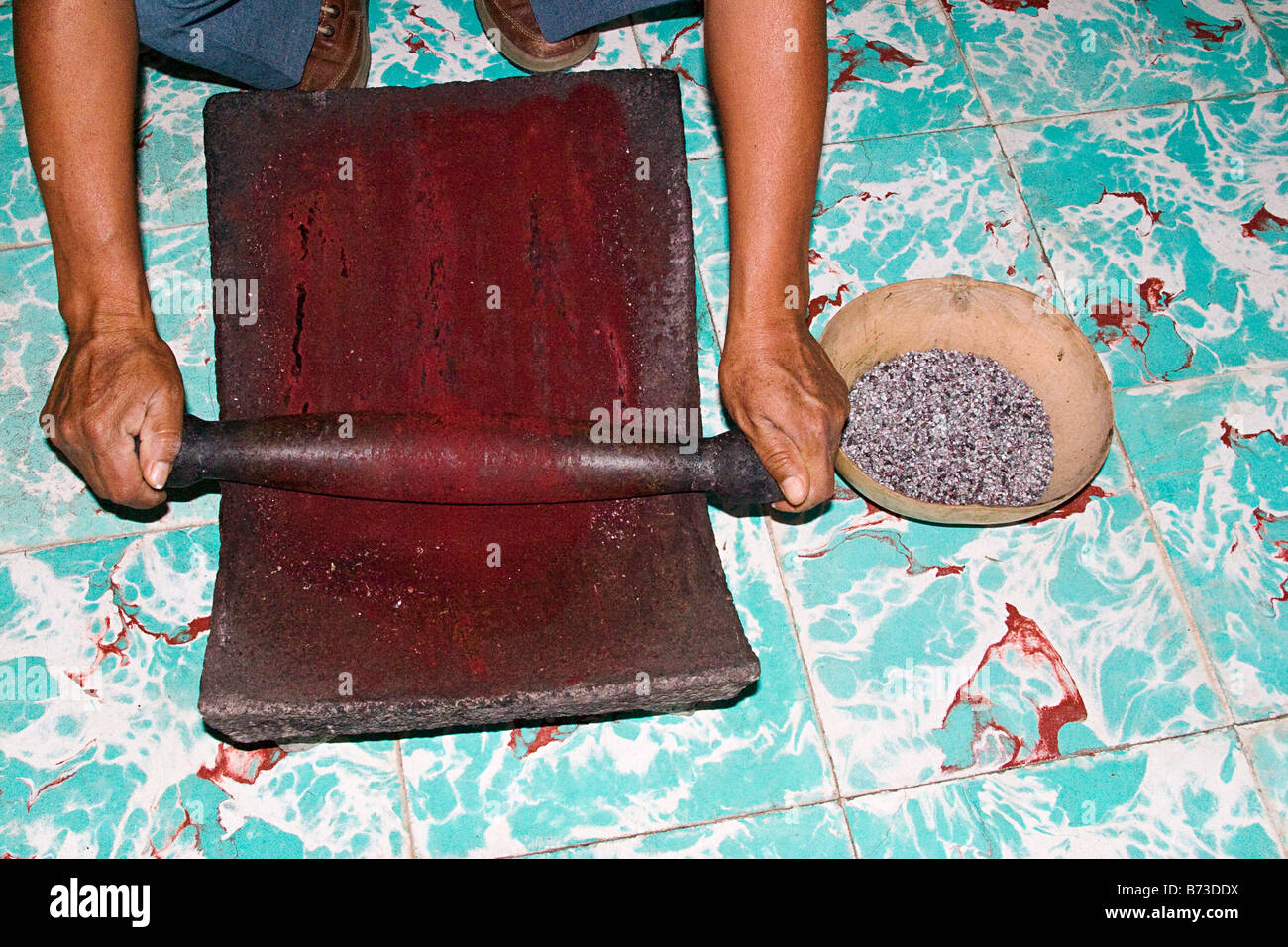 Weaver grinding cochinea bugs for natural dye Oaxaca State Stock Photo ...